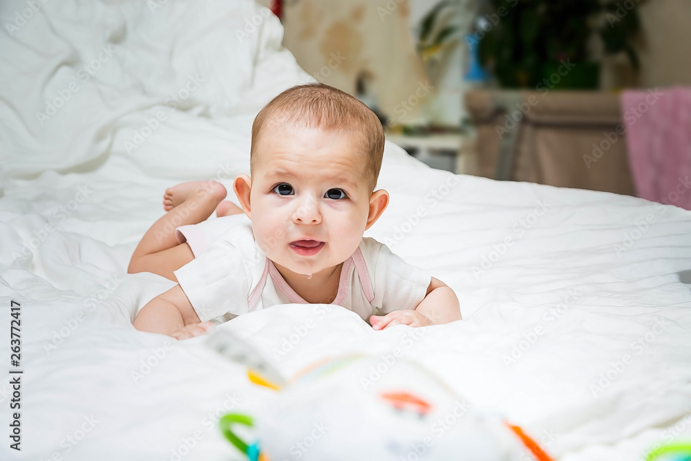 Increased salivation in the infant during teething. A baby girl in ...