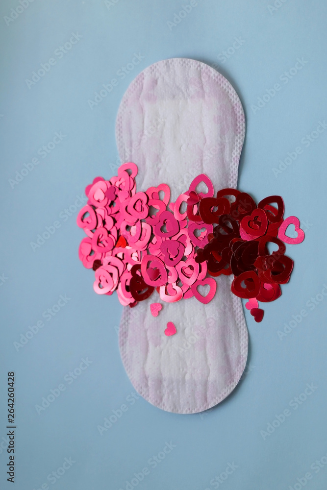 Period pad with red heart shaped sequins symbolizing menstruation. Top ...