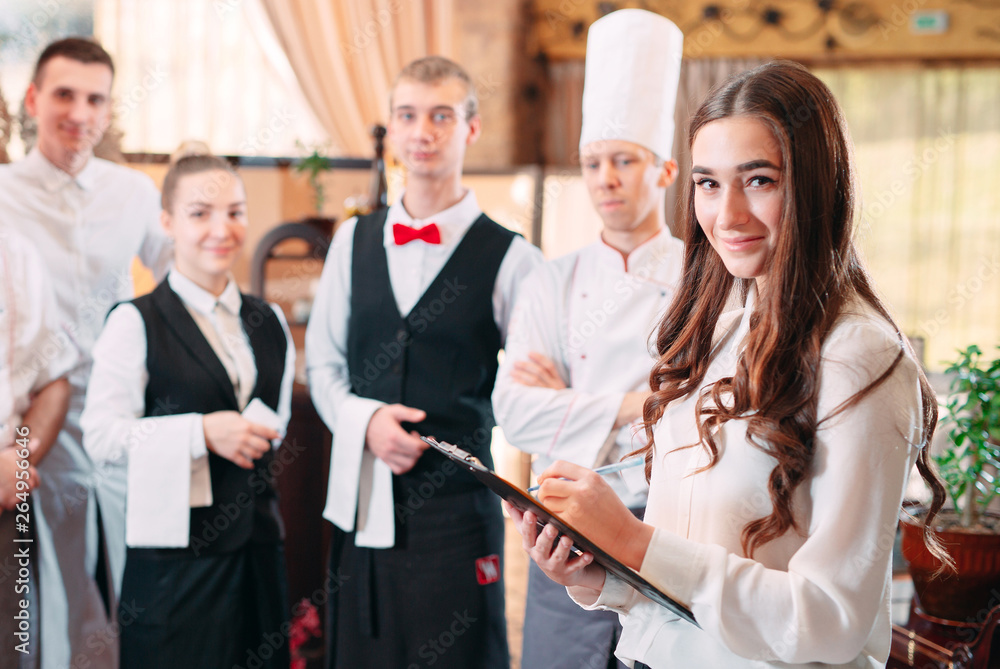 restaurant manager and his staff in kitchen. interacting to head chef ...