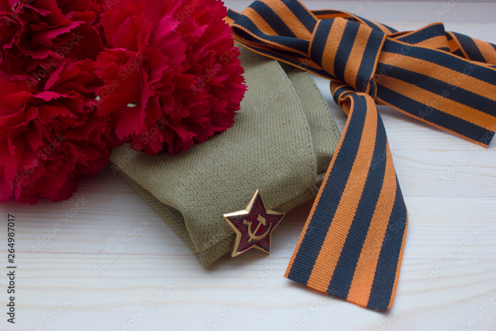 Victory day composition with clove, flight cap and saint George ribbon ...