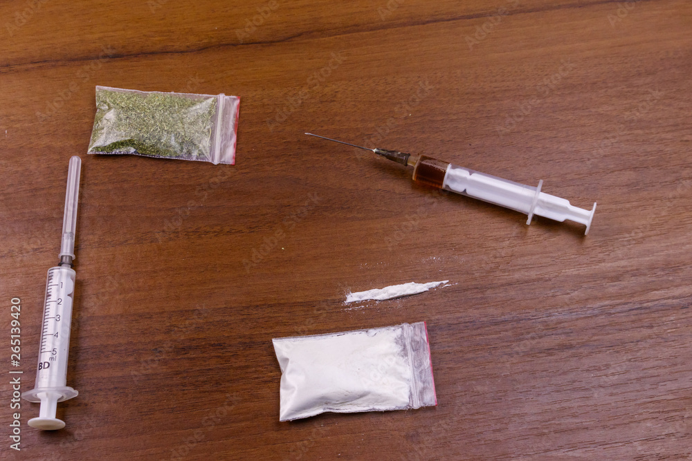 Photo Stock Different type of drugs: cocaine, heroin syringe and dried ...