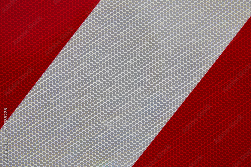 white wide diagonal line on a bright red background, honeycomb texture ...