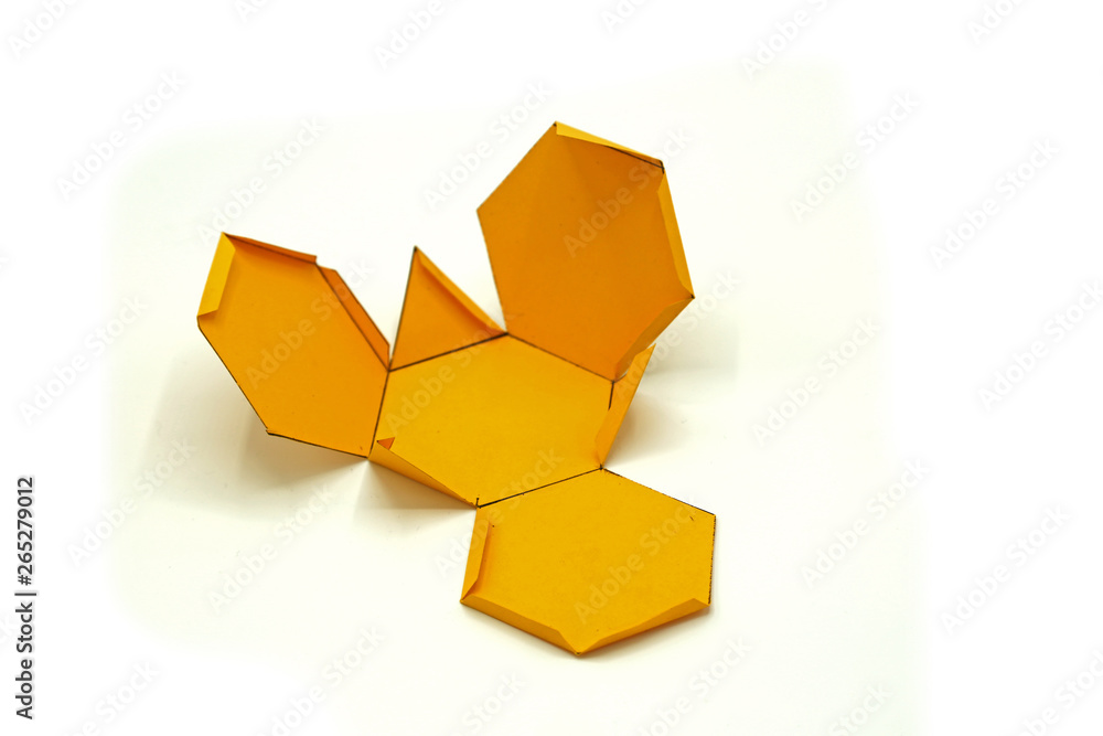 Foto de Stock Geometric shape cut out of yellow paper and photographed ...