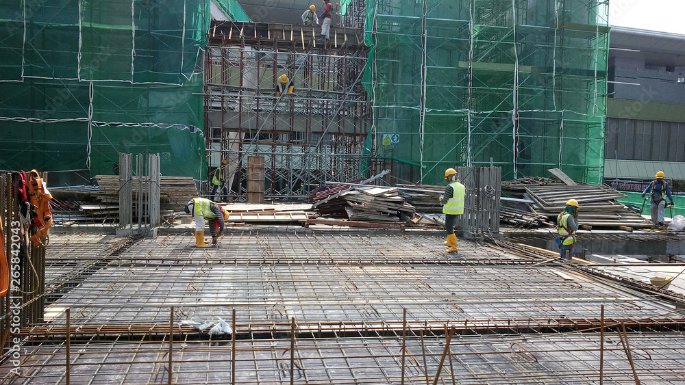 Construction workers fabricating steel reinforcement bar to form ...