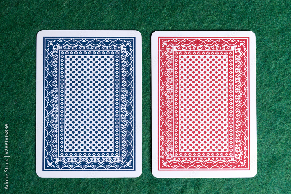 Back of the two playing cards. Red and blue color cards of the green ...