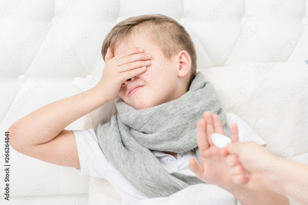 Young boy refuses to take medicine on the bed Stock Photo | Adobe Stock