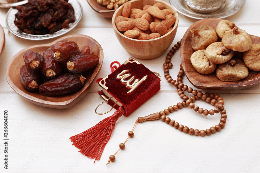 Ramadan iftar party concept. Islamic holy book Quran and rosary beads ...