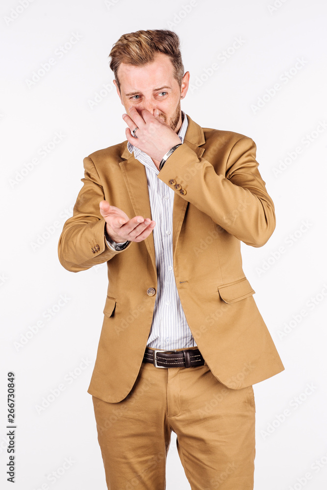 man in yellow suit closing nose because something stinks. emotions ...