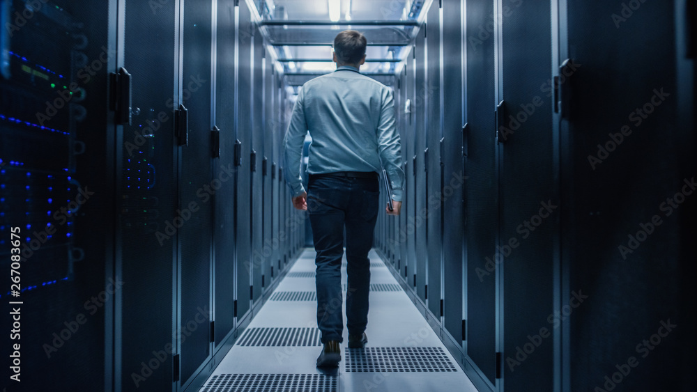 IT Engineer Walking Through Data Center with Working Server Rack to Do ...