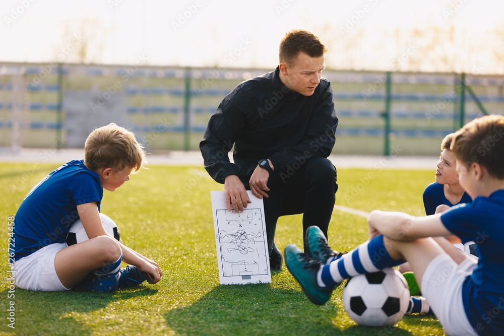Football coach coaching children. Soccer football training session for ...