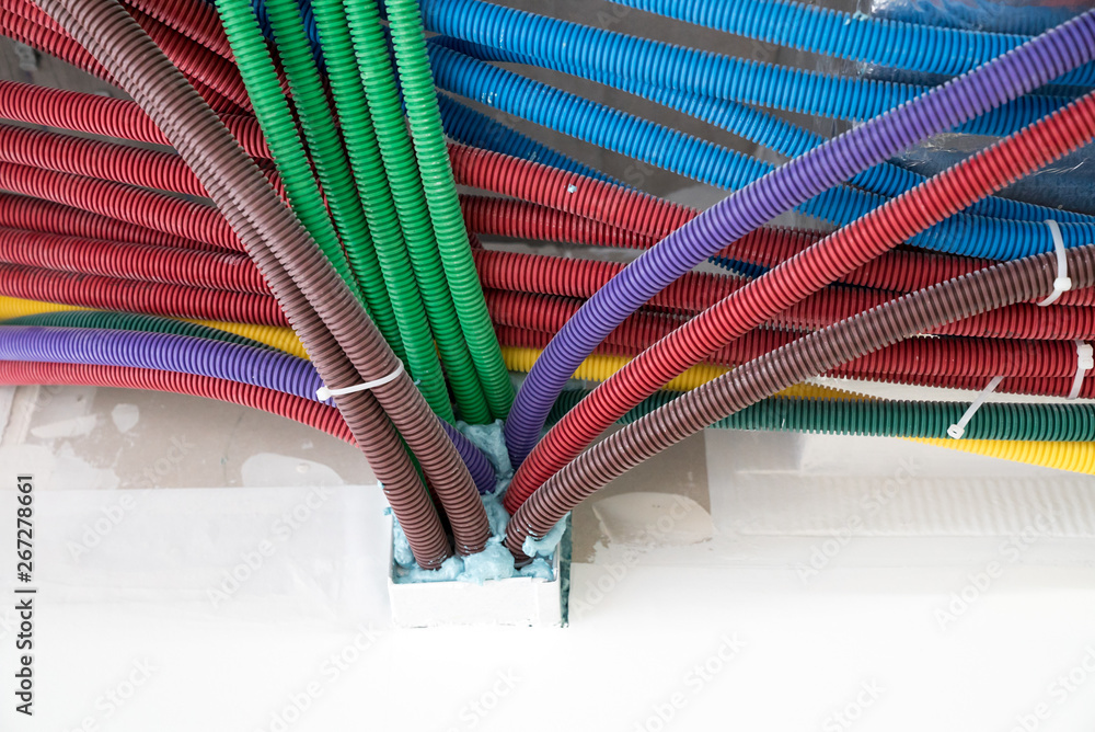 colorful plastic tubes for electrical wires in the sub ceiling in a ...