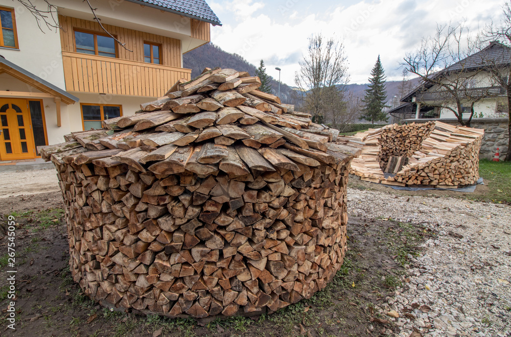 round wood pile behind new one being build Stock Photo | Adobe Stock
