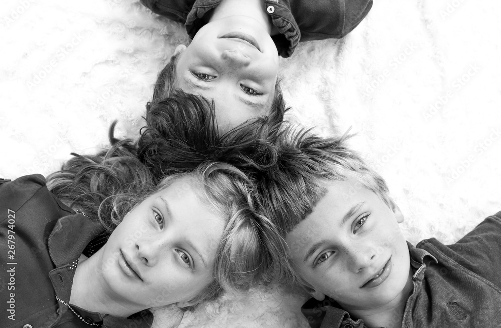 Black and white portrait of three young siblings seen from above Stock ...