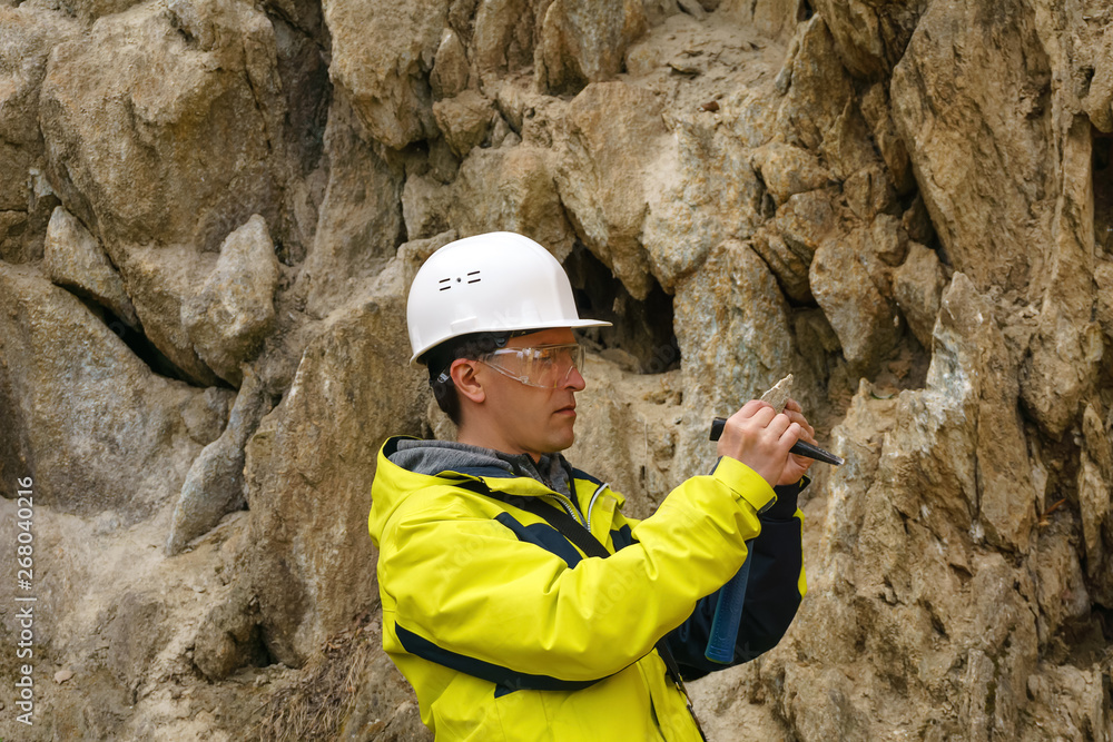 geologist examines a sample of stone outdoor Stock Photo | Adobe Stock