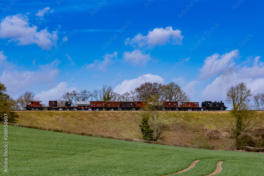 Steam locomotive working hard pulling a train Stock Photo | Adobe Stock