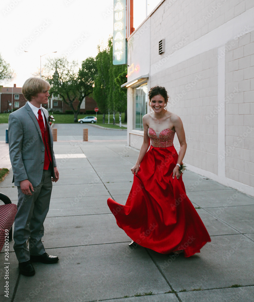 teenage couple dressed up for high school prom having fun before the ...