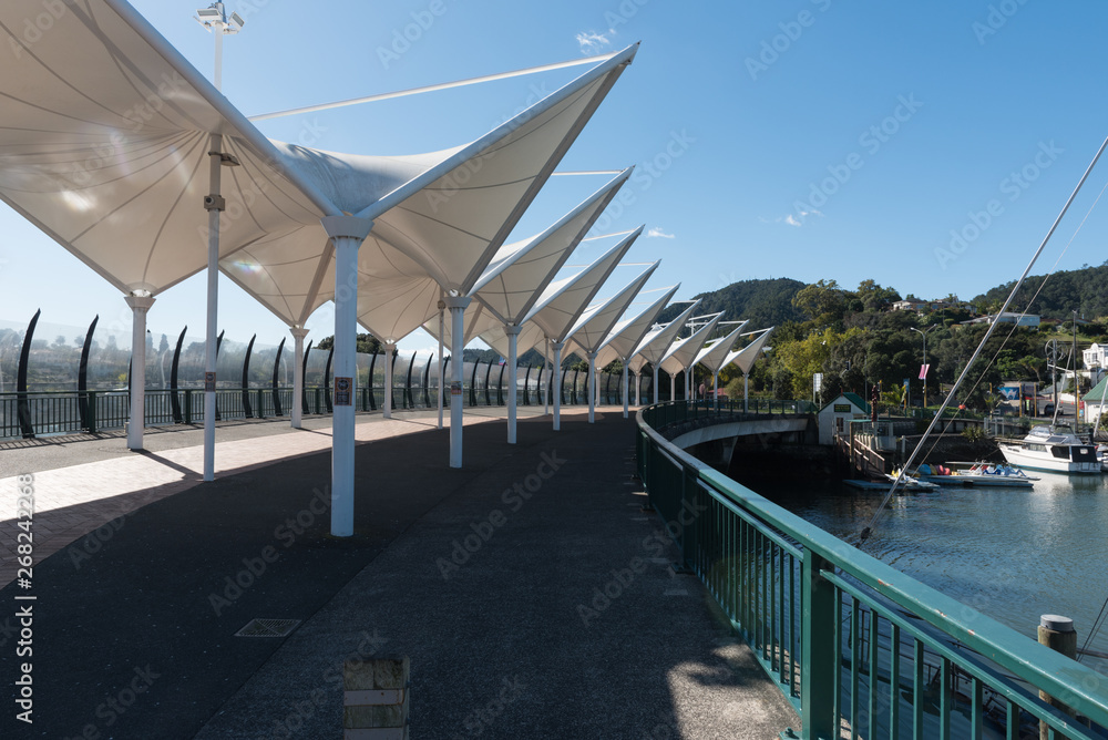 Pedestrian bridge with a canvas canopy across the Hatea River ...