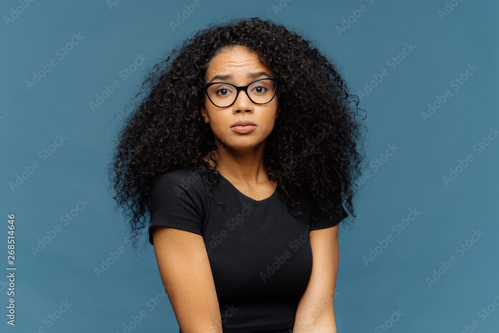 Photo of indignant puzzled Afro American woman looks surprisingly at ...