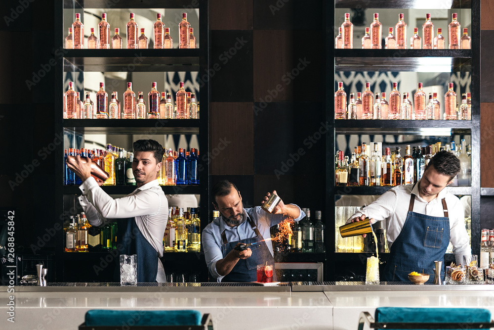 Professional team of young bartenders working Stock Photo | Adobe Stock