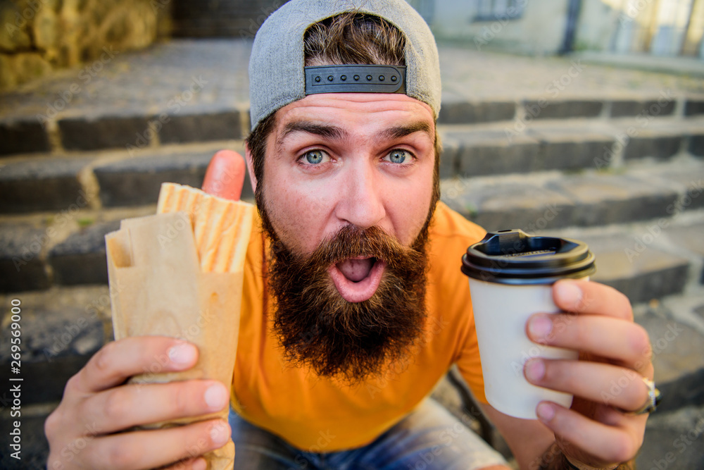 Urban lifestyle nutrition. Junk food. Carefree hipster eat junk food ...