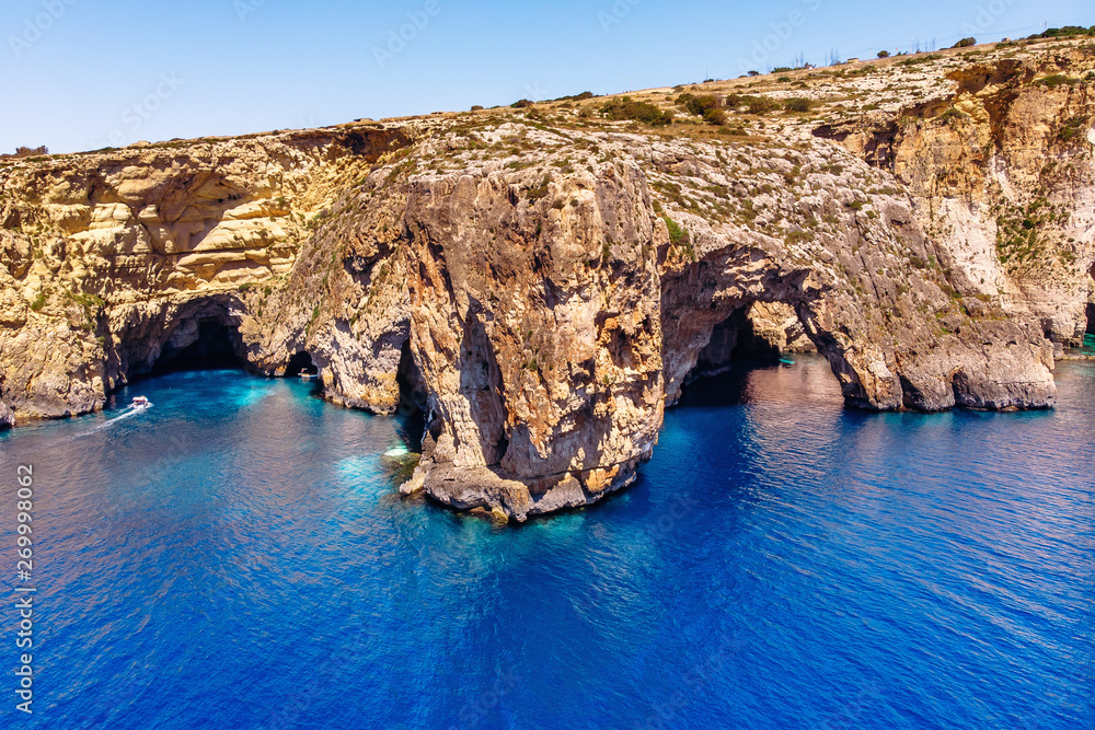 Blue Grotto in Malta. Pleasure boat with tourists runs. Natural arch ...