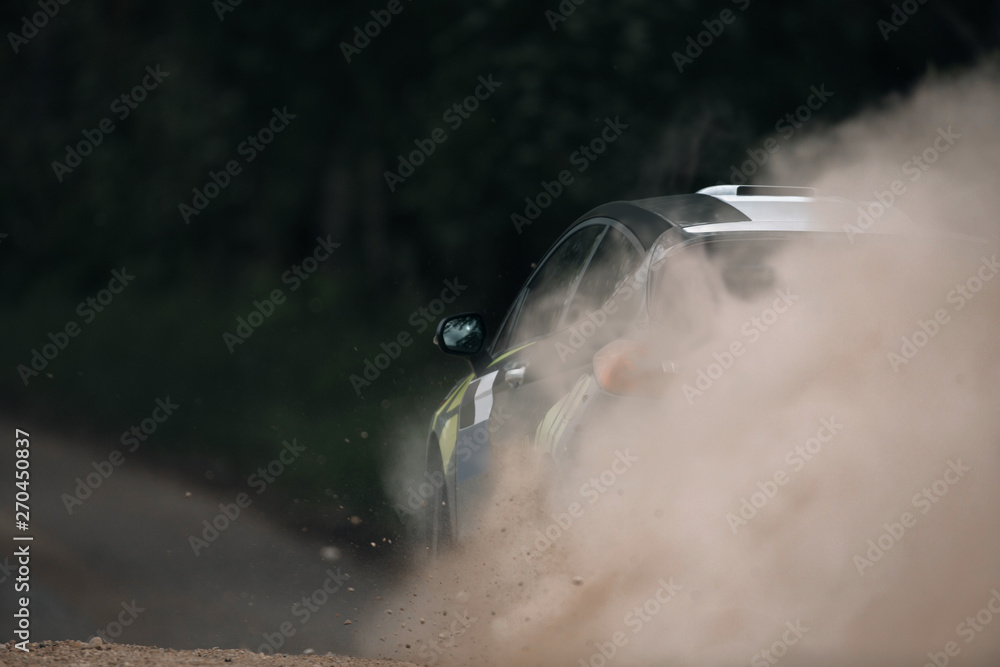 Rally car make a turn with the clouds of sands and dust. Fast moving ...