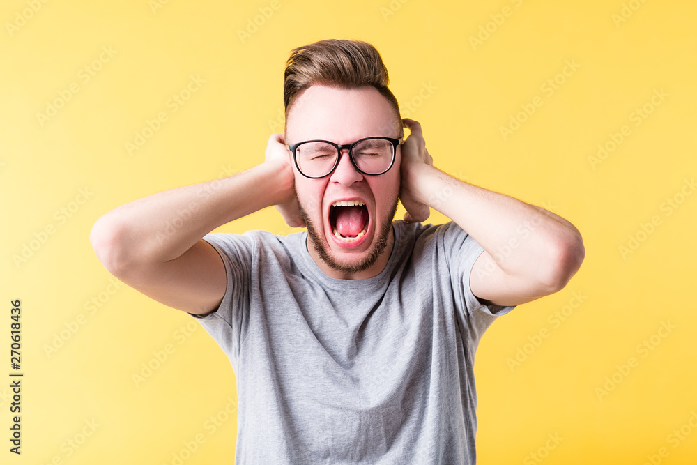 Foto de Stock Stress strain tension trauma. Young man closing ears ...