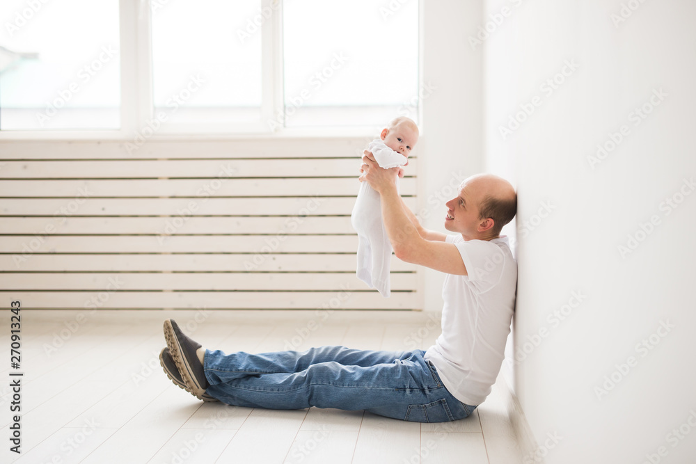 Parenting, family and fatherhood concept - Bald father sitting on the ...