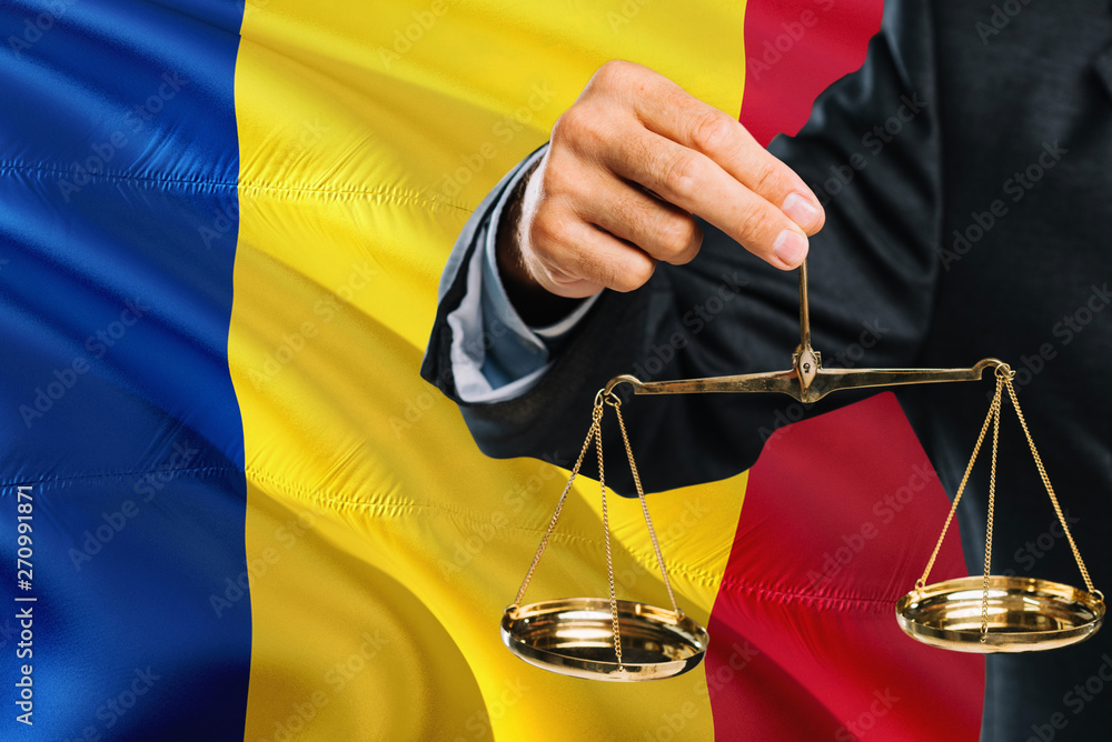 Romanian Judge is holding golden scales of justice with Romania waving ...