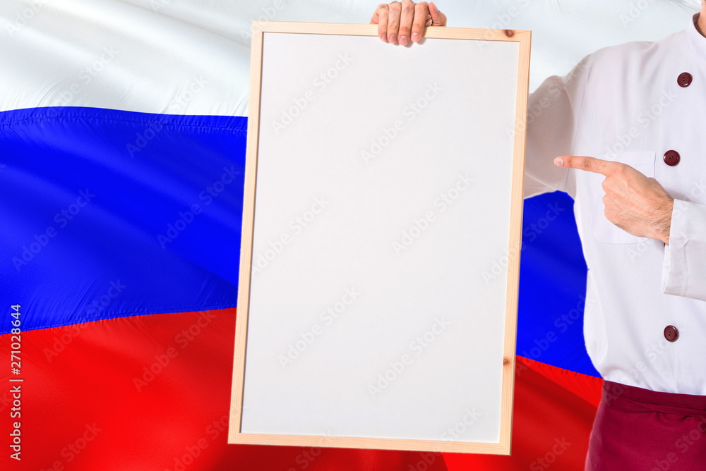 Russian Chef holding blank whiteboard menu on Russia flag background ...