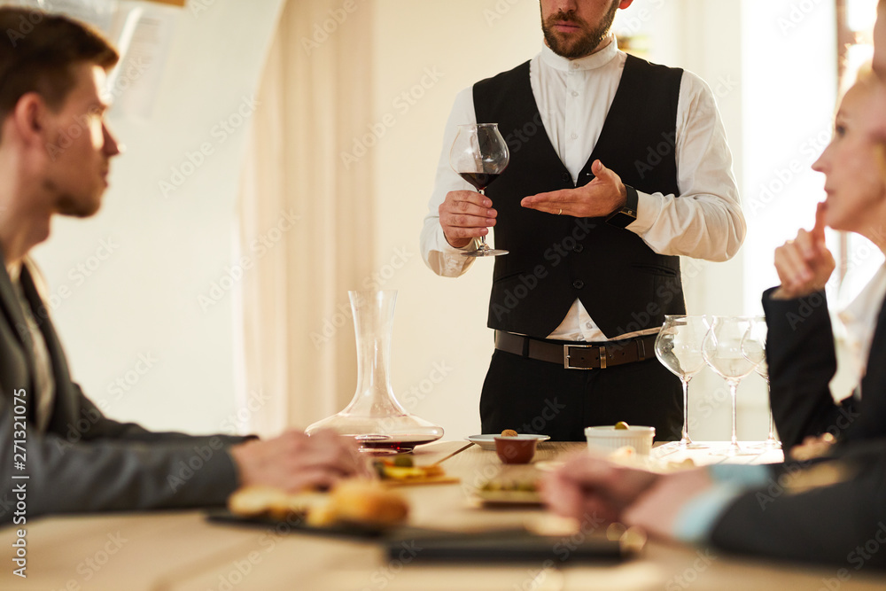 Mid section portrait of professional sommelier giving wine tasting ...