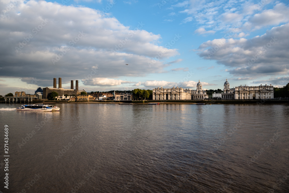 Thames River commuter ferry passing Greenwich riverfront buildings ...