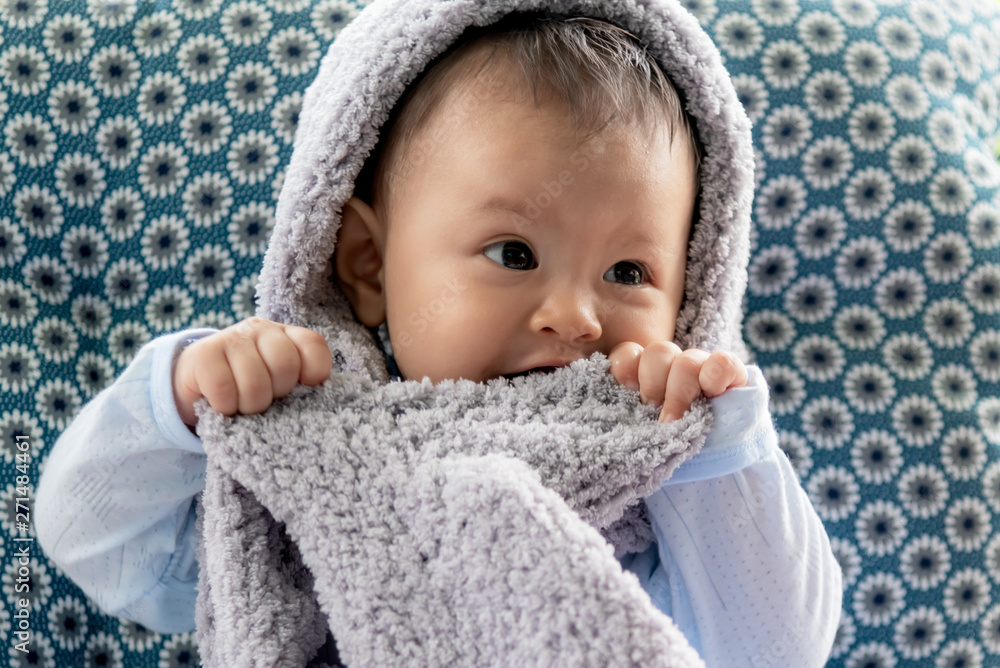 Portrait images of Cute baby is enjoying the scarf bite, Because his ...