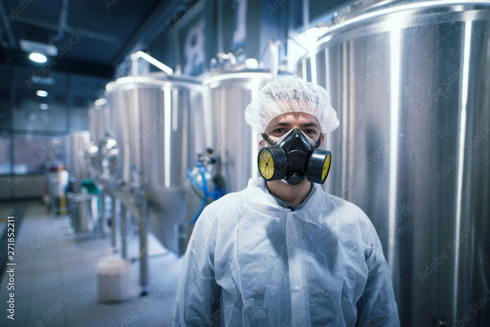 Portrait of industrial worker technologist wearing hazmat suit in ...
