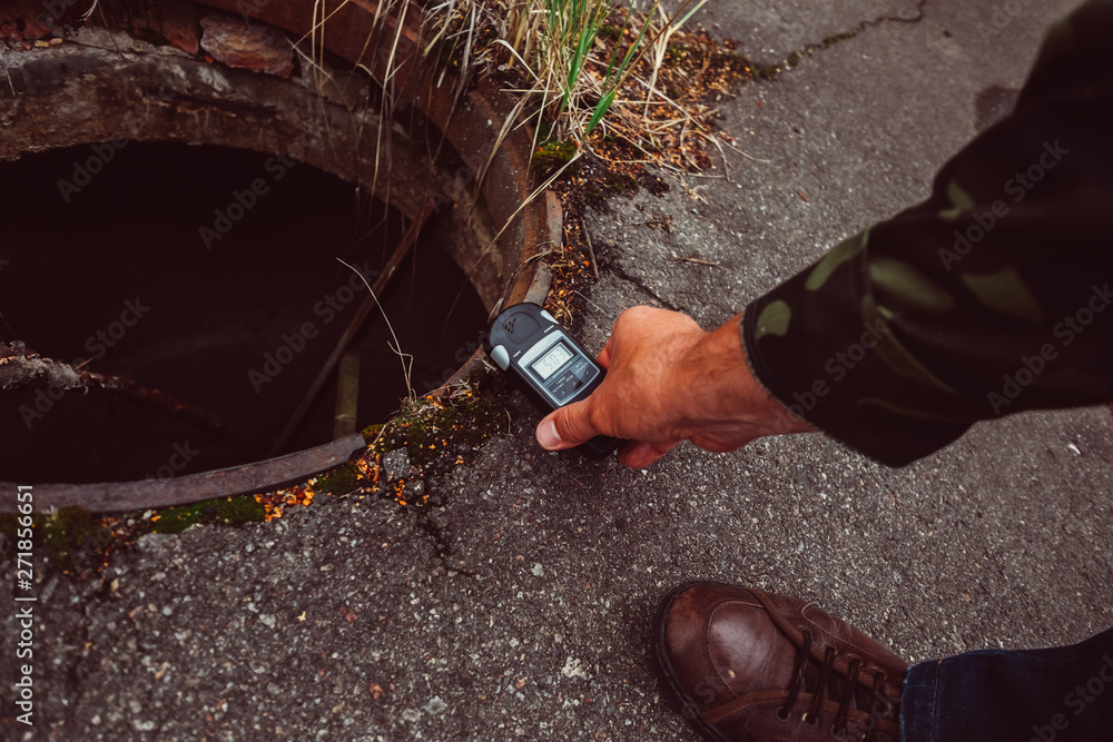 Chernobyl Exclusion Zone, Ukraine. Man holding in hand a Geiger counter ...