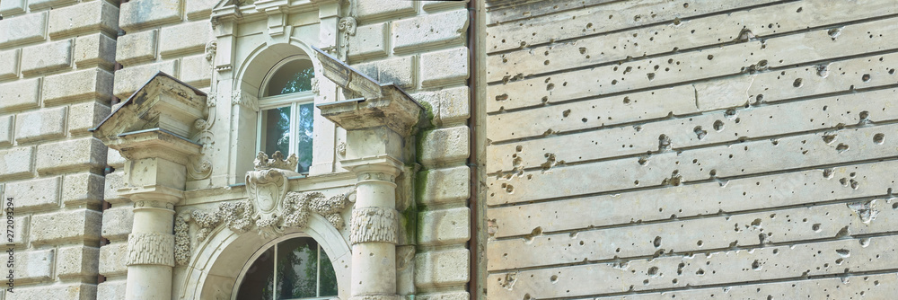 Berlin old derelict building entrance and wall ridden with bullet holes ...
