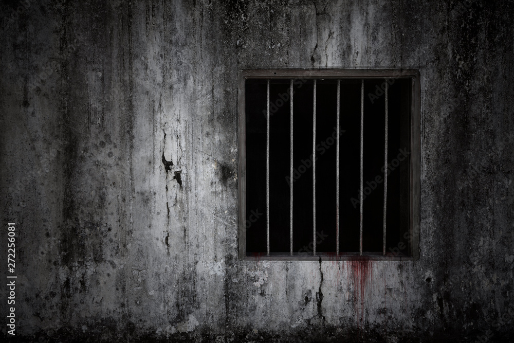 Bloody scary on the window with rusty bars on old grungy prison cell ...