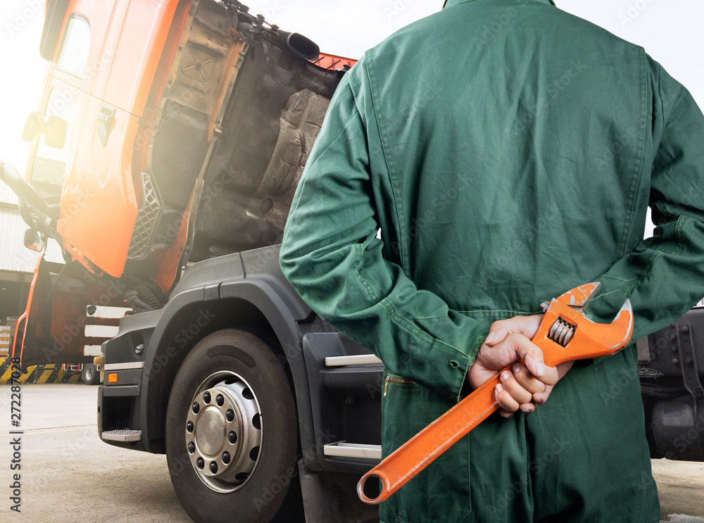 truck maintenance and repairing. professional auto mechanic holding ...