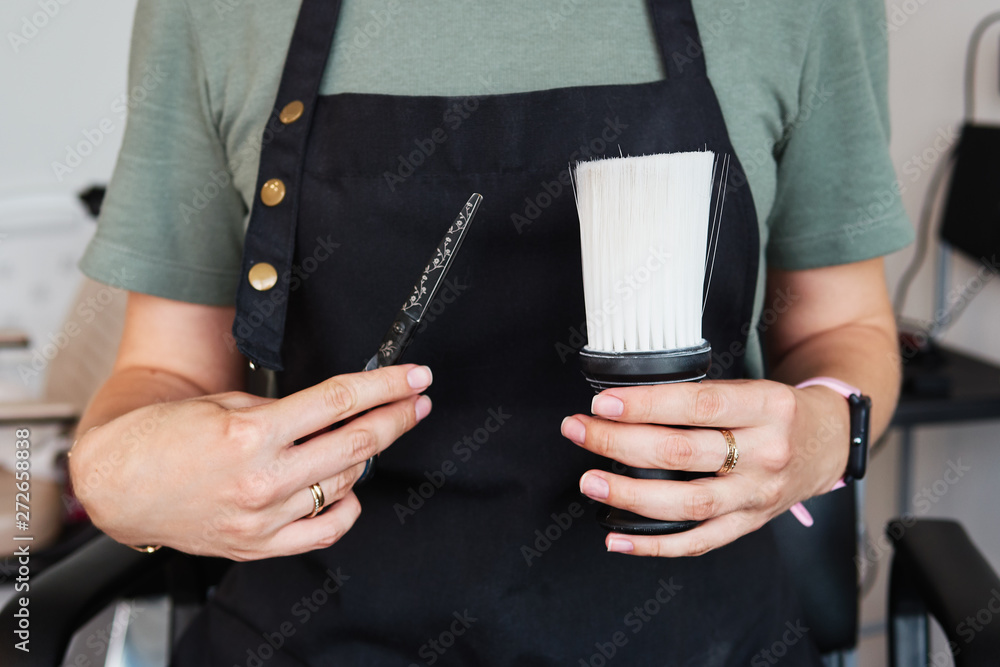 Concept shot of body parts self employed barber woman in black apron ...