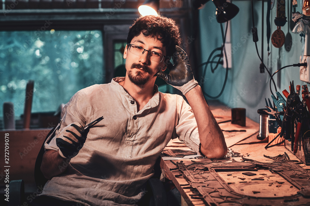 Happy smiling craftsman at his restouration workshop with plies and ...