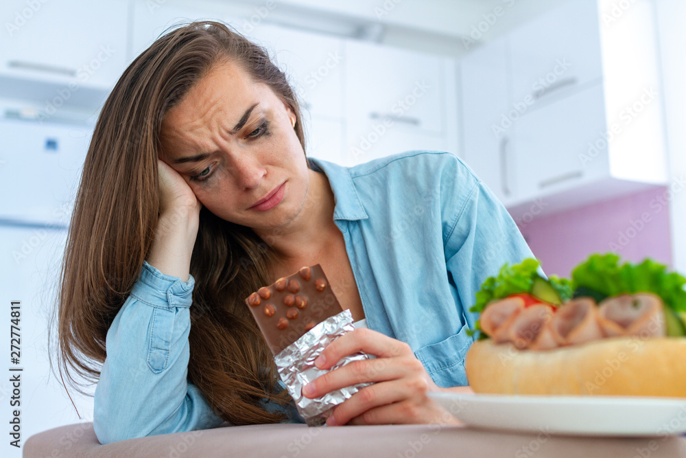 Sad, unhappy stressed crying woman eating chocolate and sweets because ...