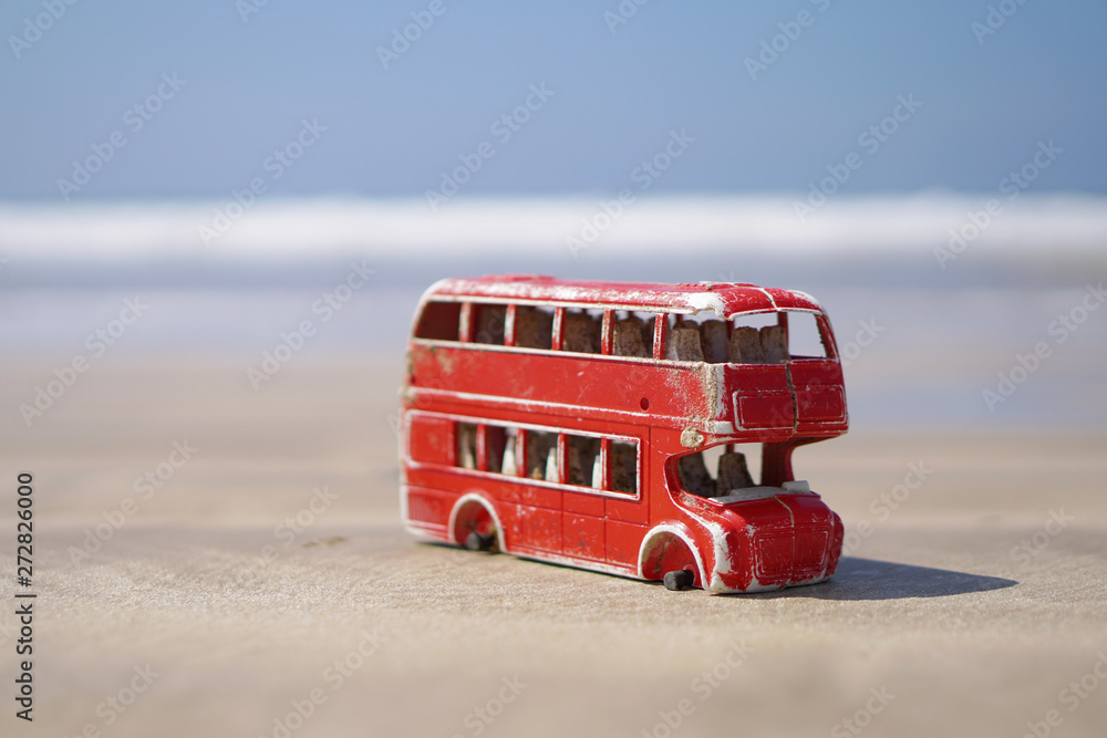 Red toy bus in nature pollutes the earth's ecosystem. English bus ...