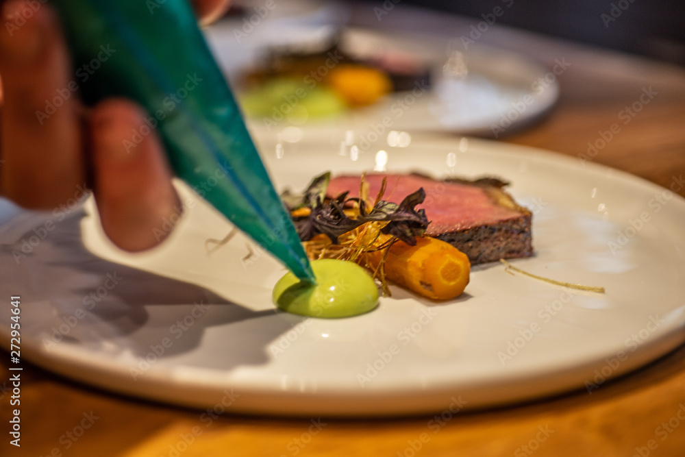 Chef plating steak dinner Stock Photo | Adobe Stock