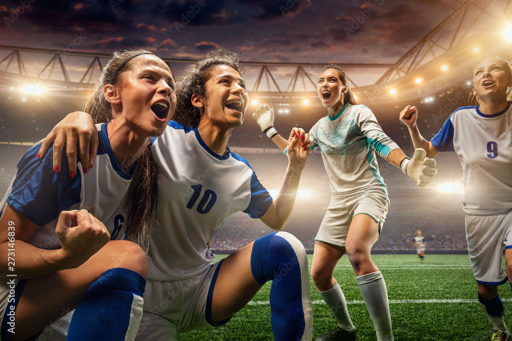 Happy Female Soccer players on a professional soccer stadium. Girls ...