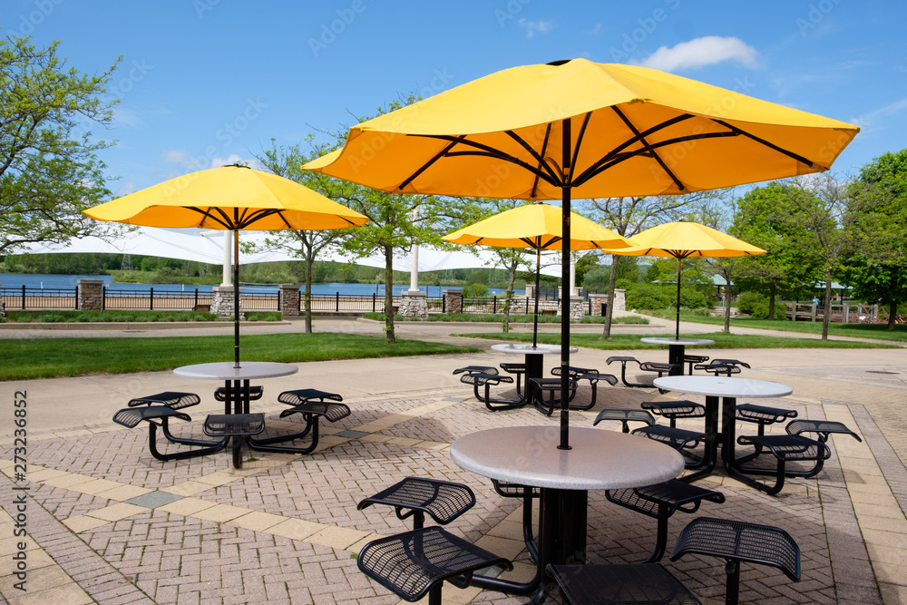 Resting area in park with seats, tables and parasol Stock Photo | Adobe ...
