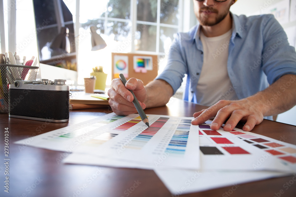 Graphic design and color swatches and pens on a desk. Architectural ...