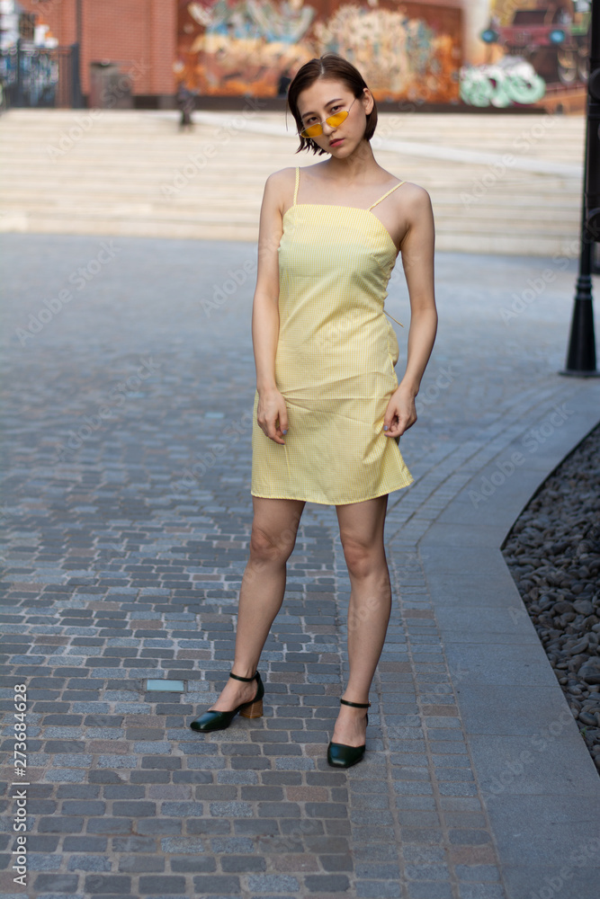 Asian Chinese model girl influencer street shot. Wearing yellow ...