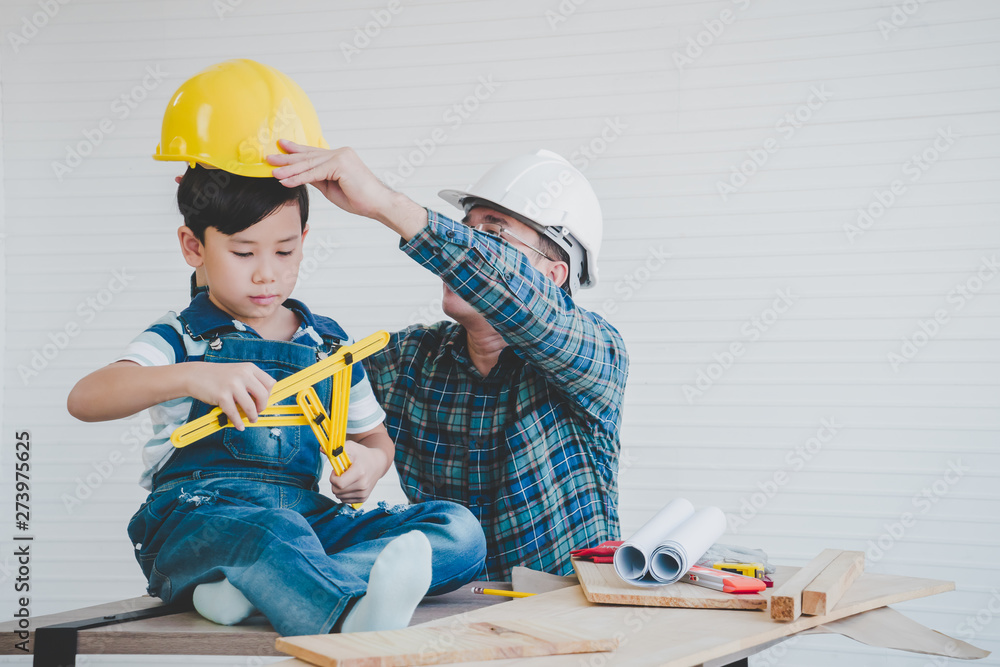 Engineer Father is placing safety hat for his son to teach him about ...