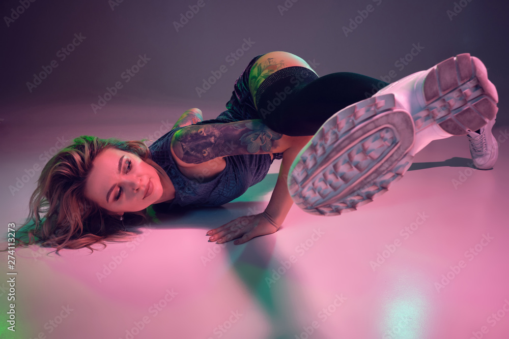 beautiful caucasian blonde girl in velour blue booty shorts and black stockings dancing twerk ...