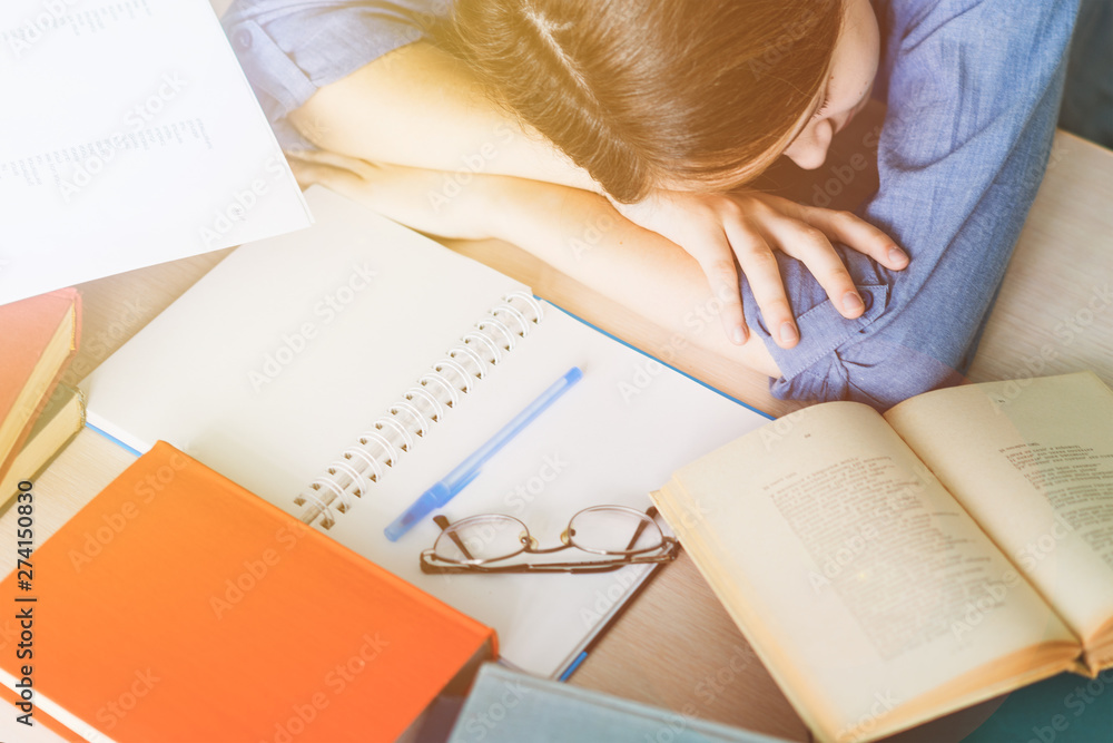 Stressed college student tired of hard learning with books in exams ...